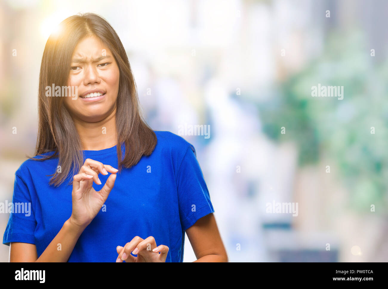 Young asian woman over isolated background disgusted expression ...