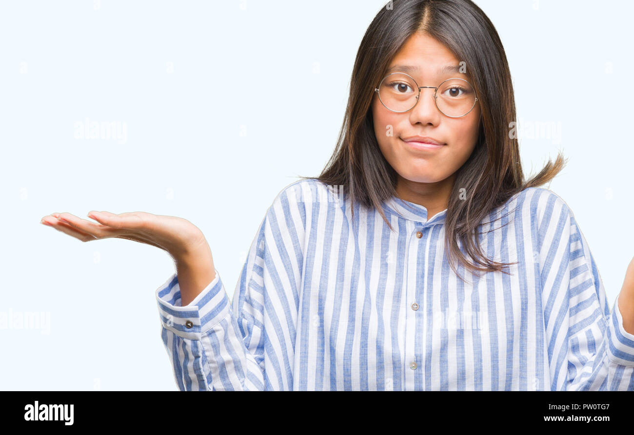 Young asian woman over isolated background clueless and confused ...