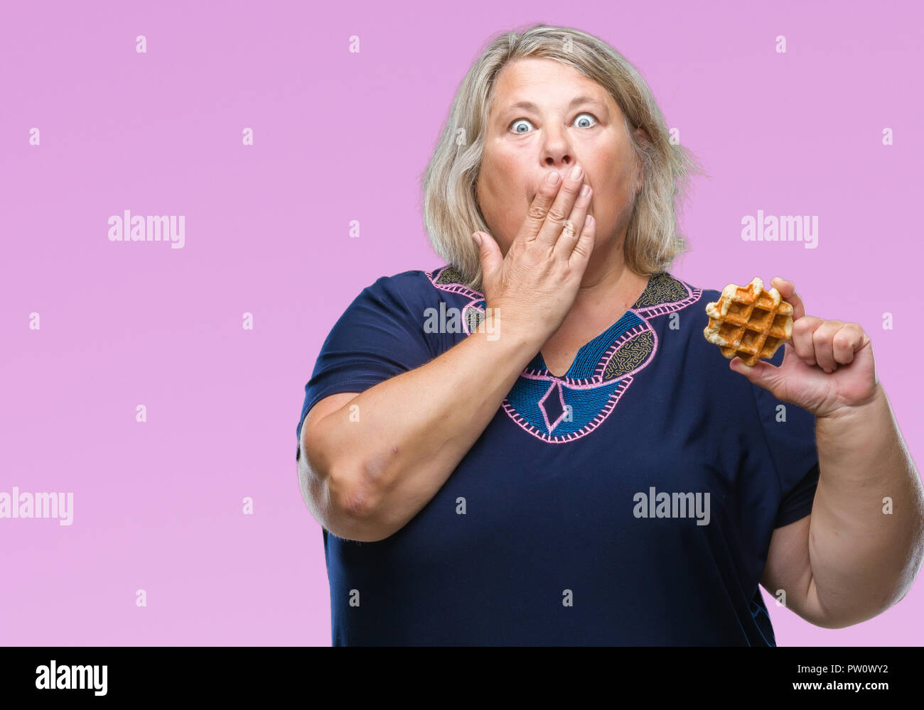 Senior plus size caucasian woman eating waffle over isolated background ...