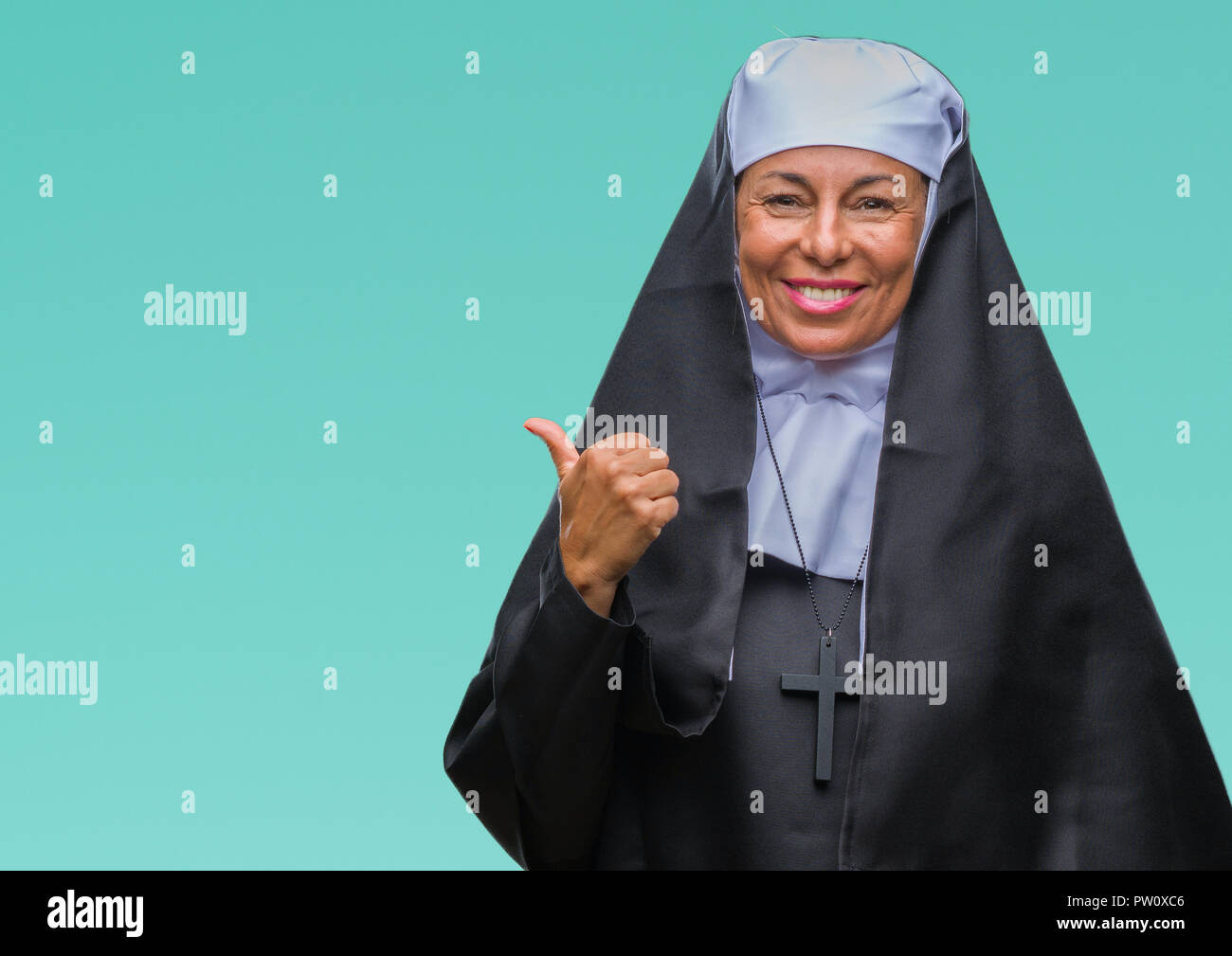 Middle age senior christian catholic nun woman over isolated background ...