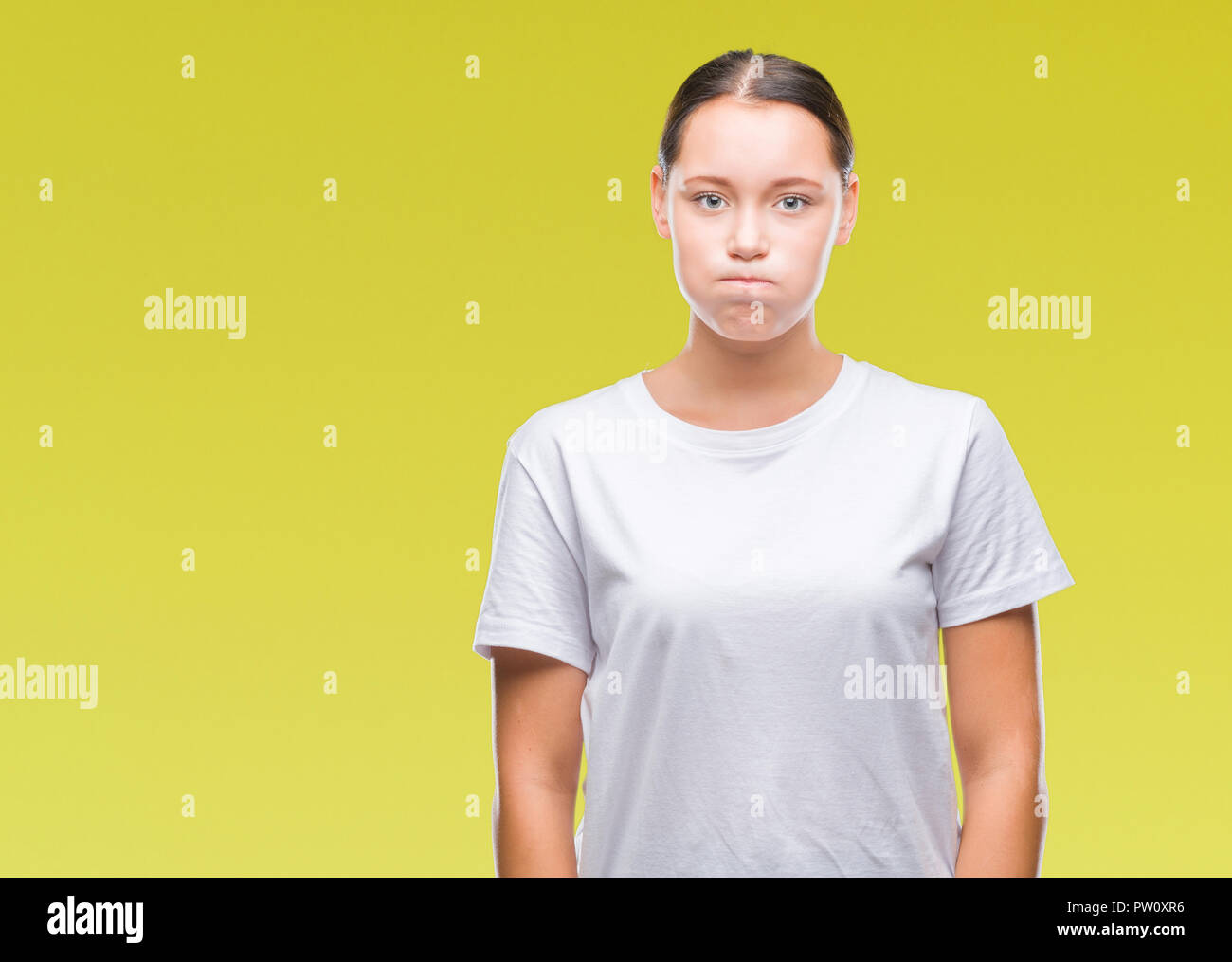 Young beautiful caucasian woman over isolated background puffing cheeks ...