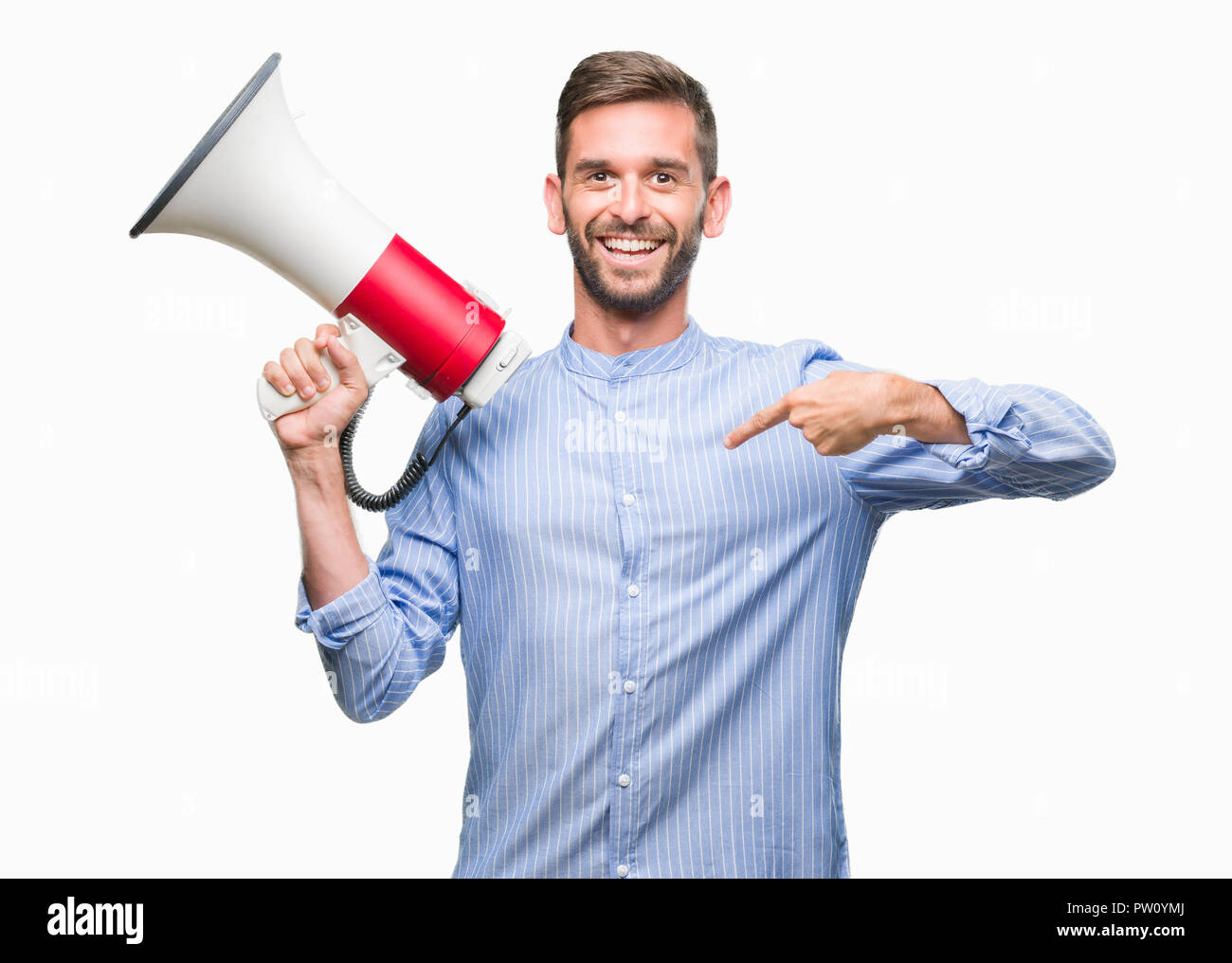 Young handsome man yelling through megaphone over isolated background ...