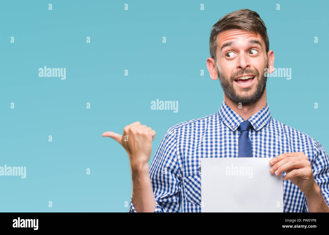 Young handsome man holding blank paper over isolated background ...