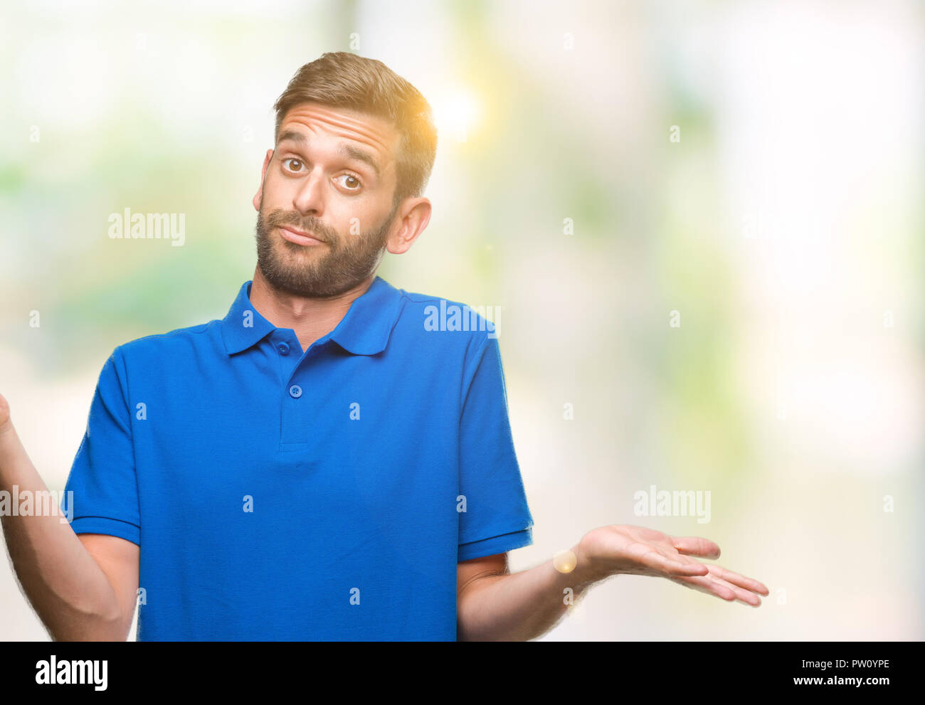 Young handsome man over isolated background clueless and confused ...