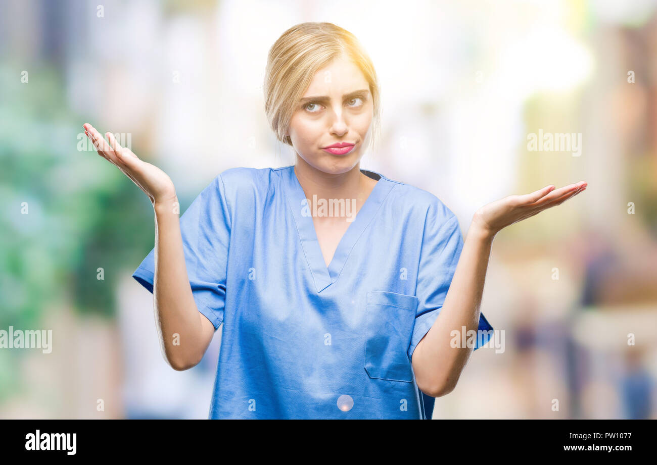 Young beautiful blonde doctor surgeon nurse woman over isolated ...