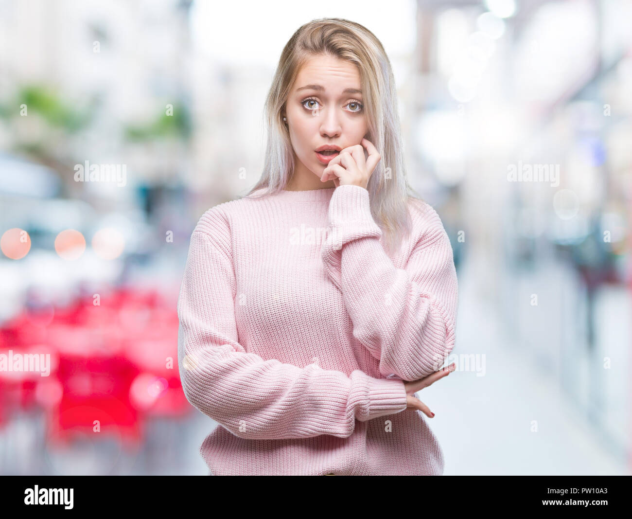 Young blonde woman wearing winter sweater over isolated background ...