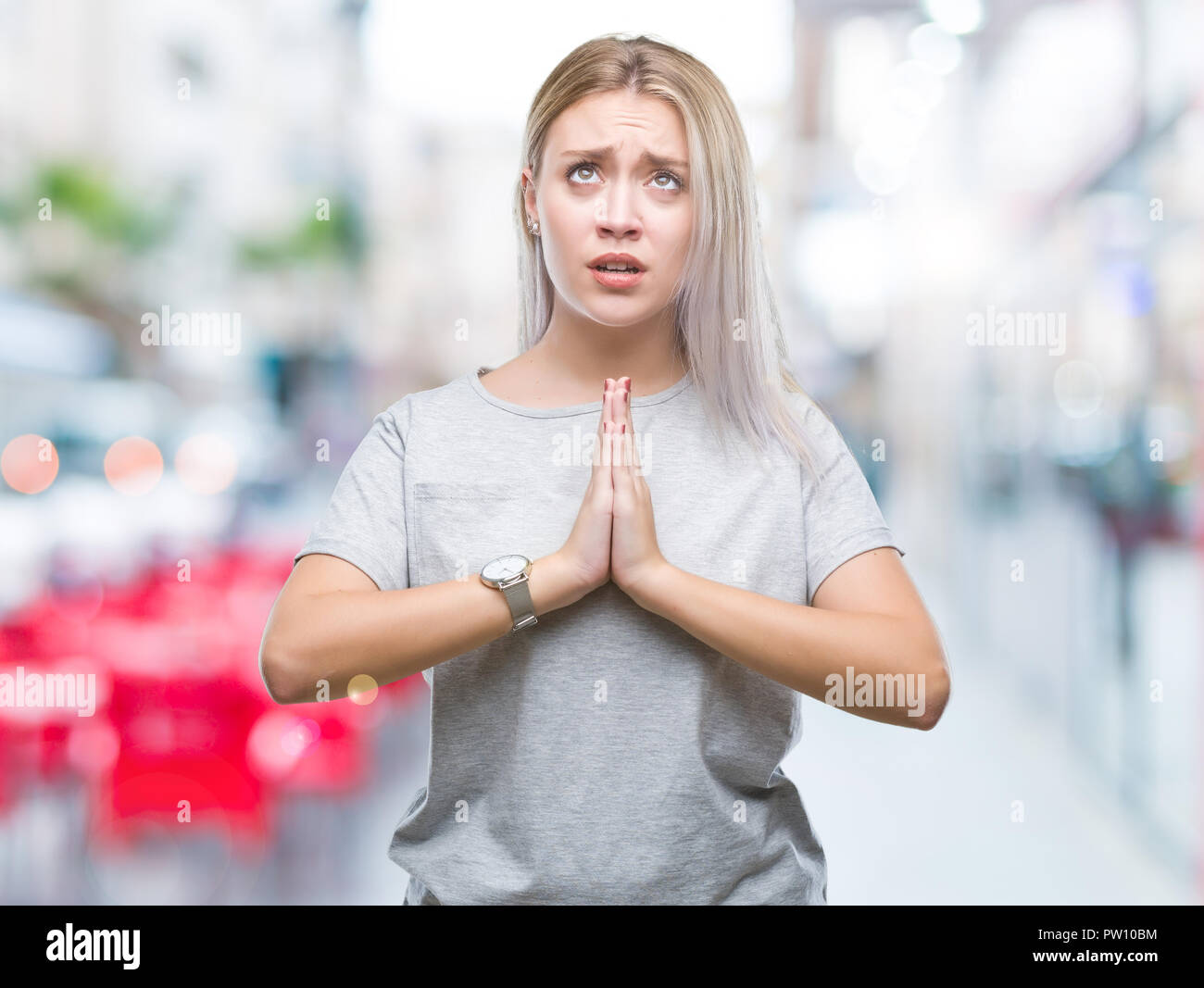 Young blonde woman over isolated background begging and praying with ...