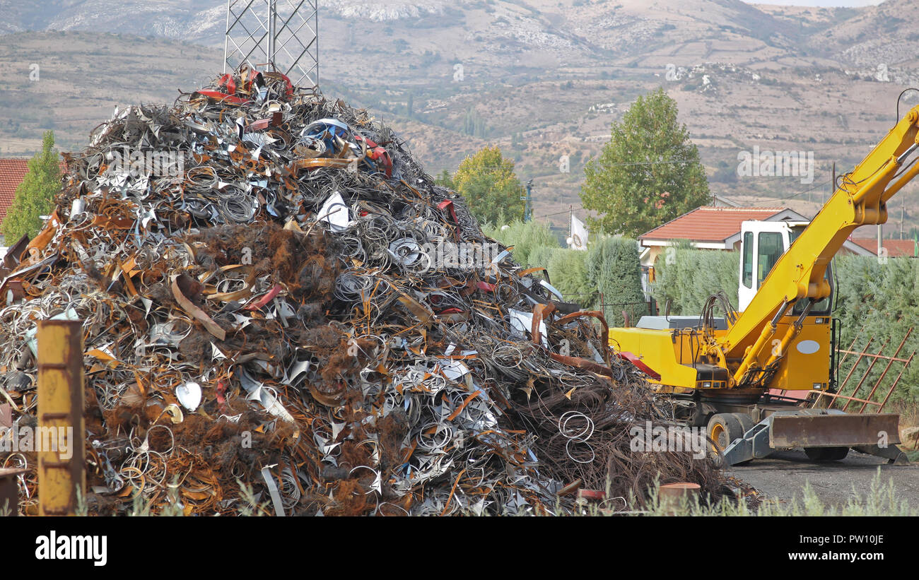Pile of Scrap Metal and Digger at Recycling facility Stock Photo - Alamy