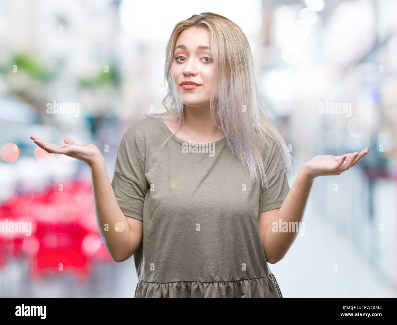 Young blonde woman over isolated background clueless and confused ...