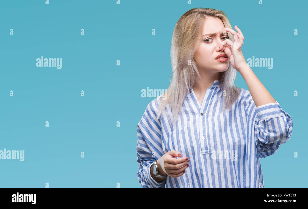 Young Blonde Woman Over Isolated Background Smelling Something Stinky