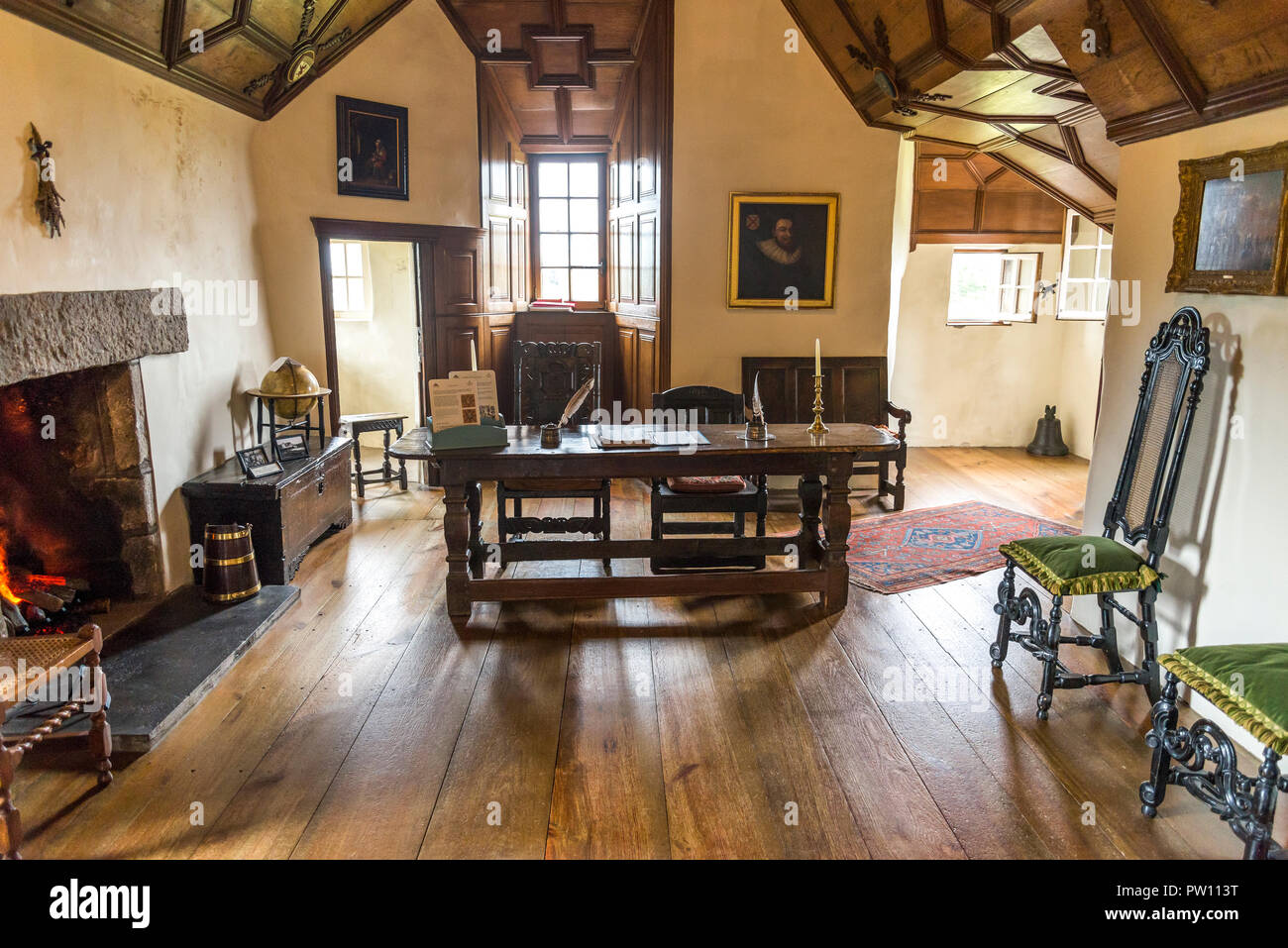 A study room with a large desk and writing accessories inside of ...