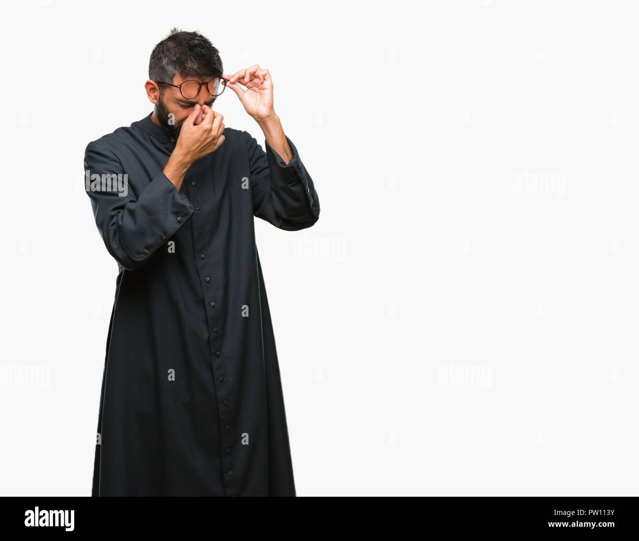Adult hispanic catholic priest man over isolated background tired ...
