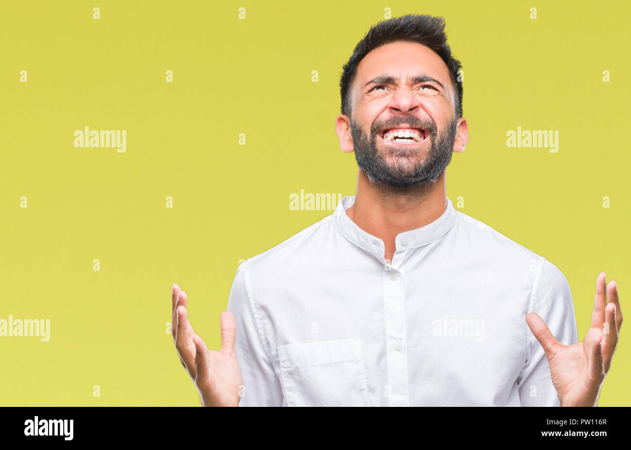 Adult hispanic man over isolated background crazy and mad shouting and ...