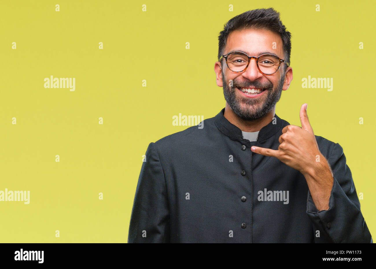 Adult hispanic catholic priest man over isolated background smiling ...