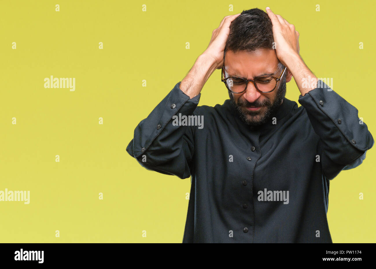 Adult hispanic catholic priest man over isolated background suffering ...