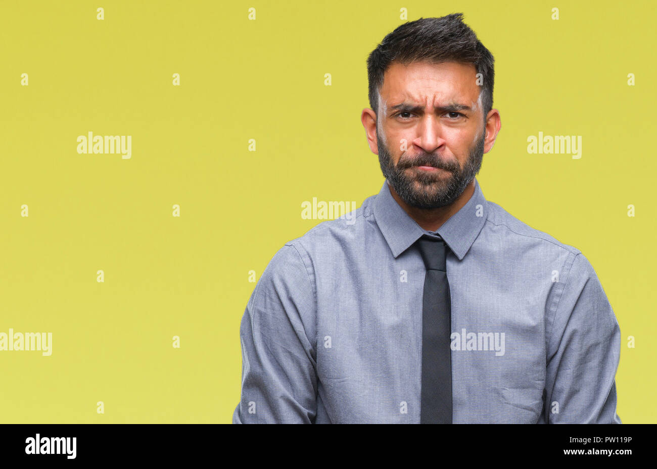 Adult hispanic business man over isolated background skeptic and ...