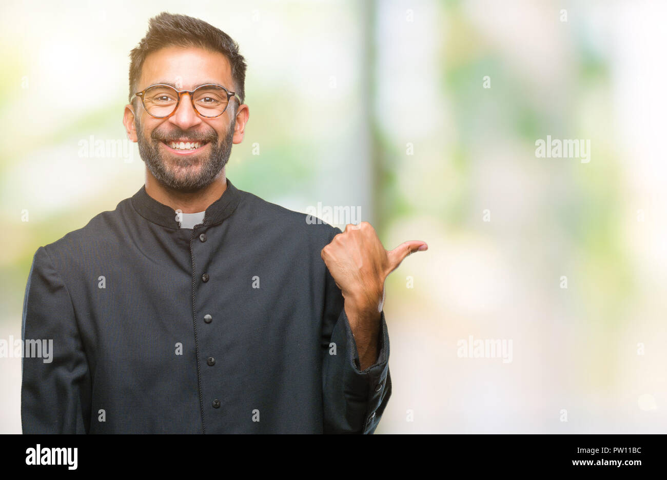 Adult hispanic catholic priest man over isolated background smiling ...
