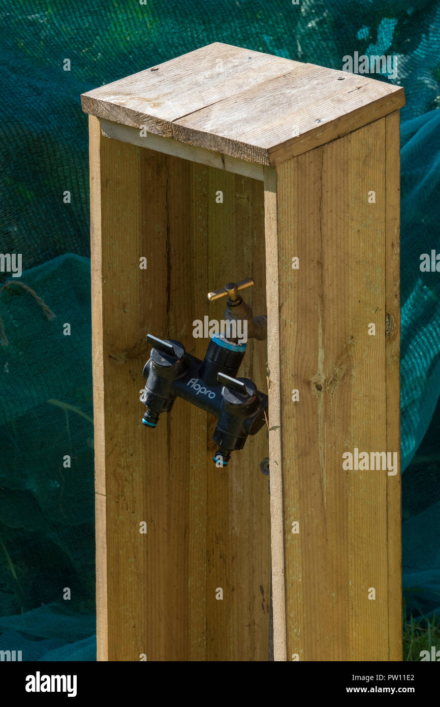 an outside tap or faucet with two hosepipe connectors for watering the ...