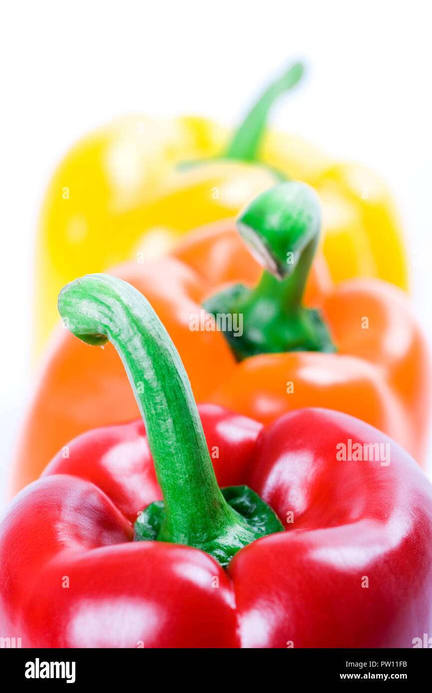three bell peppers closeup on white background Stock Photo - Alamy