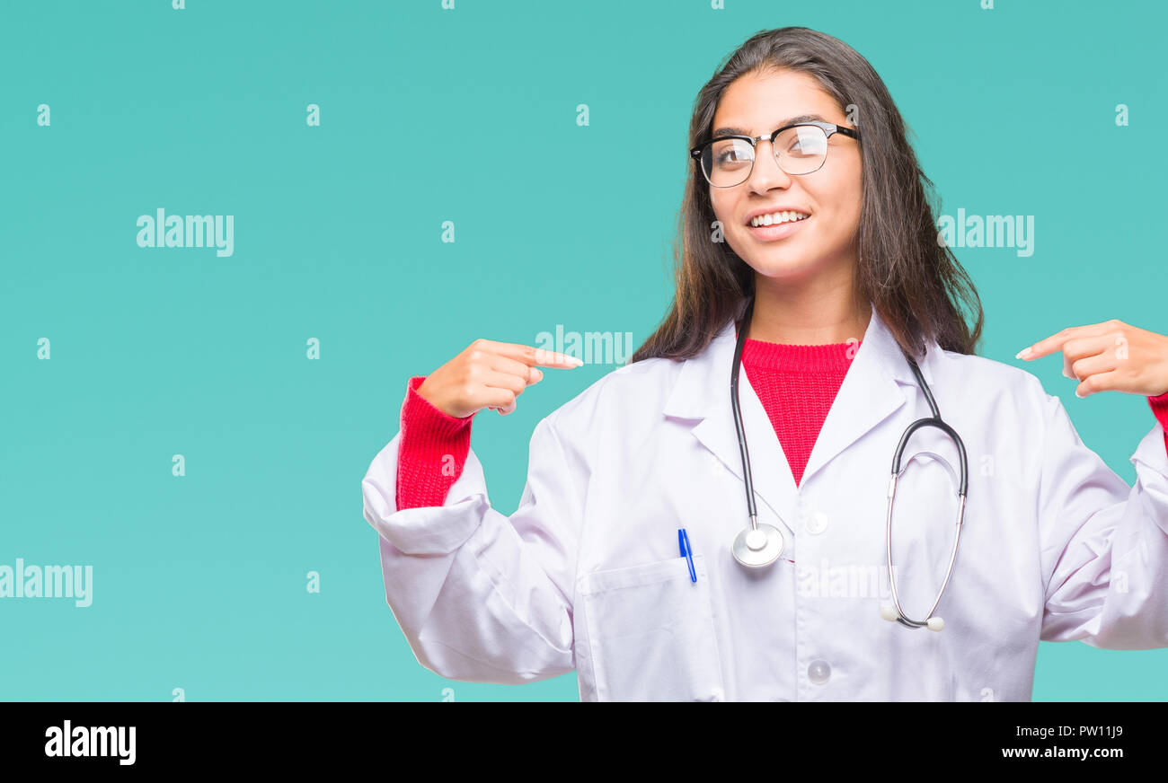 Young arab doctor woman over isolated background looking confident with ...