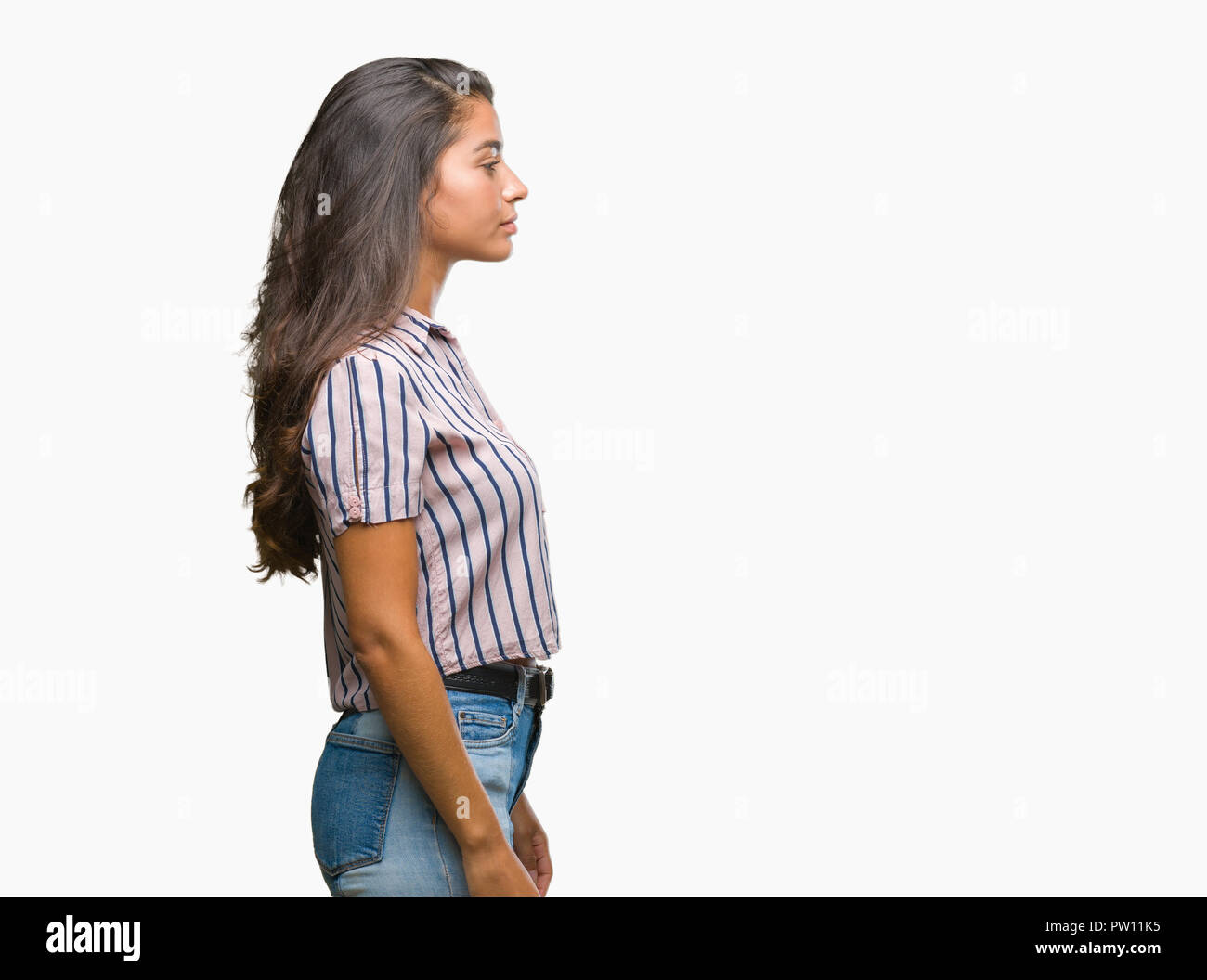 Young beautiful arab woman over isolated background looking to side ...