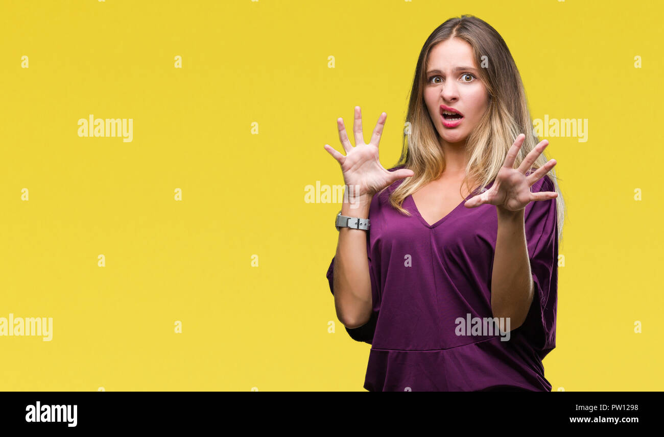 Young beautiful blonde elegant woman over isolated background afraid ...