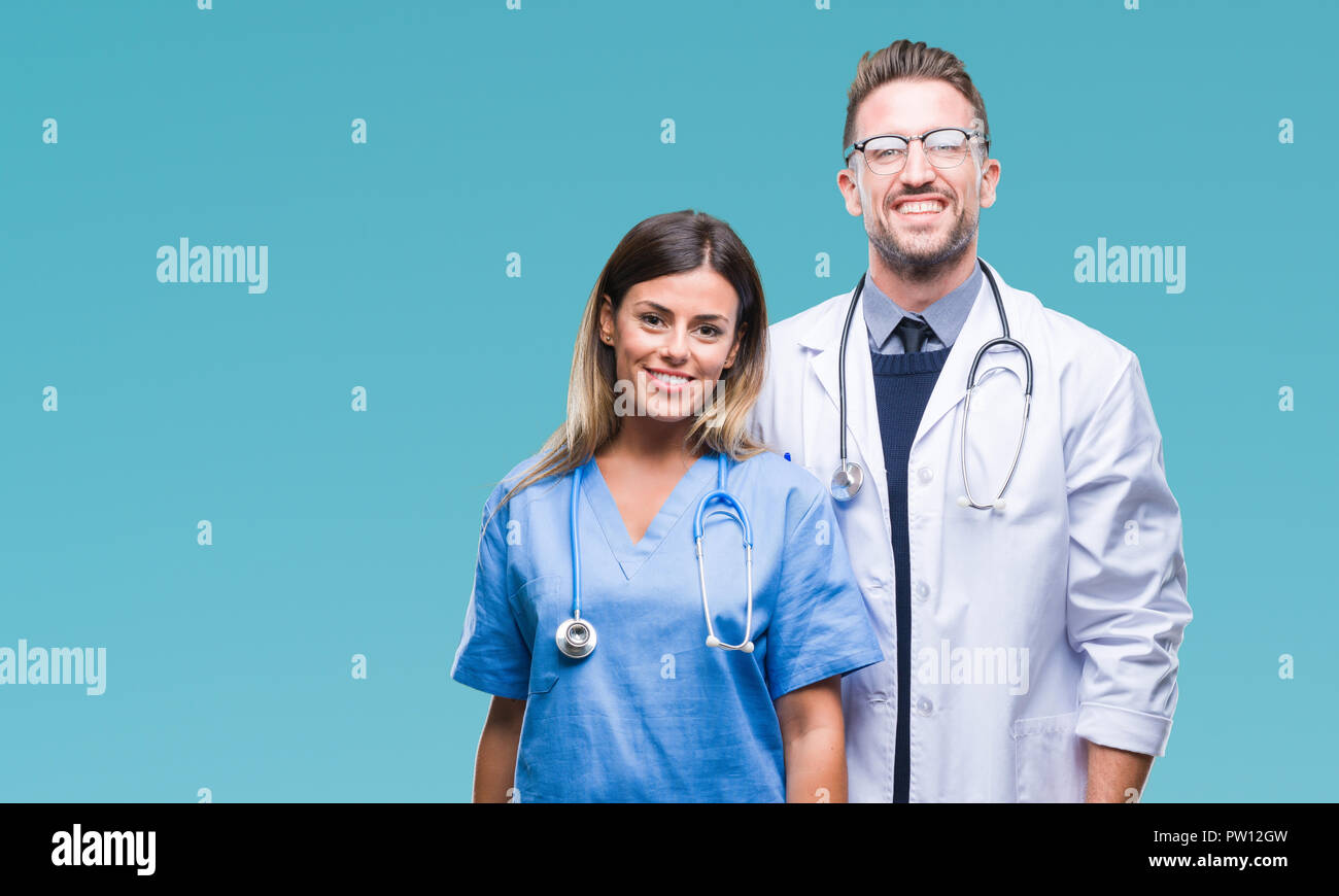 Young couple of doctor and surgeon over isolated background with a ...