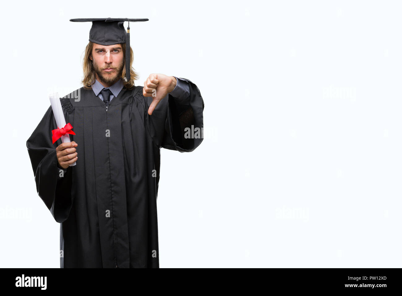 Young handsome graduate man with long hair holding degree over isolated ...