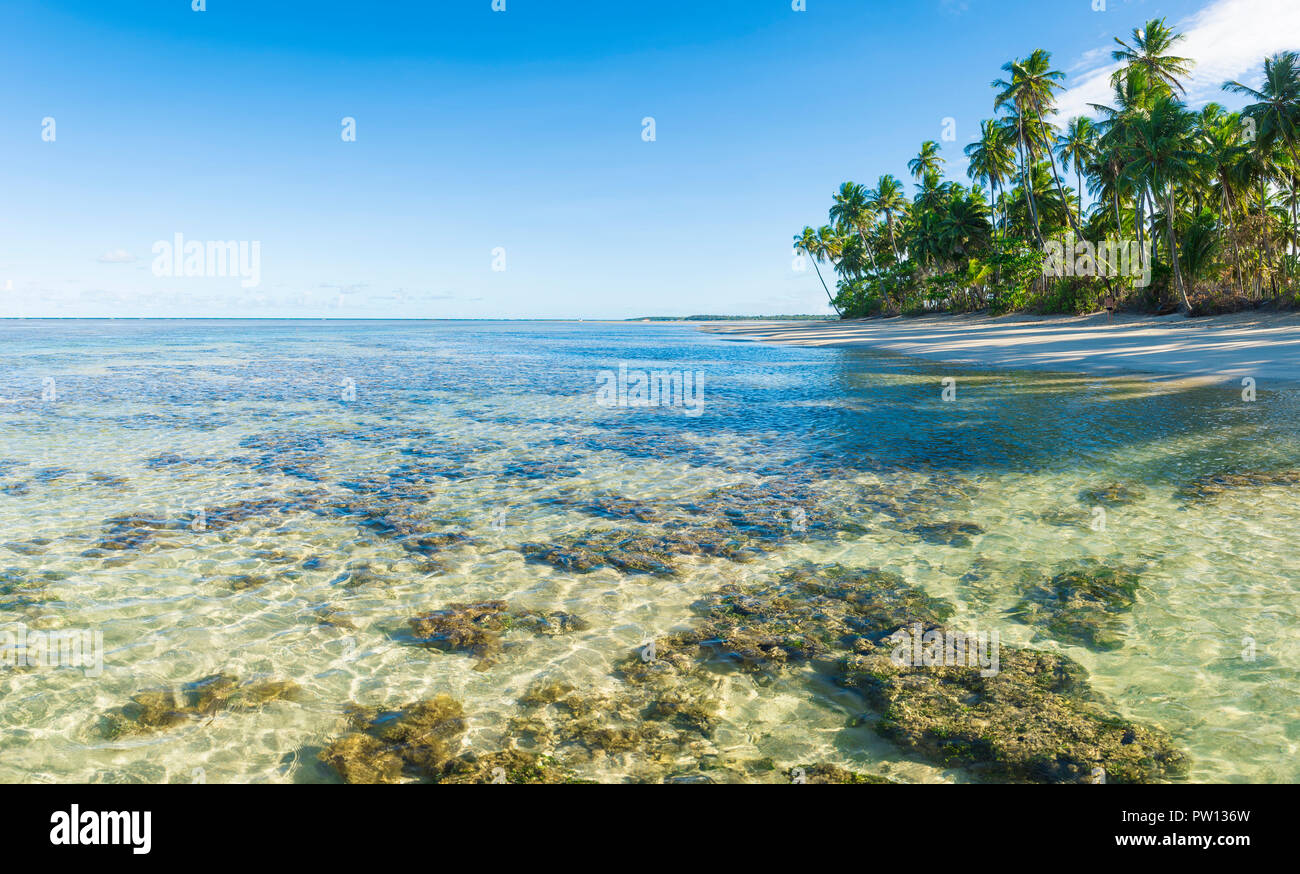 Bright scenic panorama view of remote tropical beach and coral reef ...