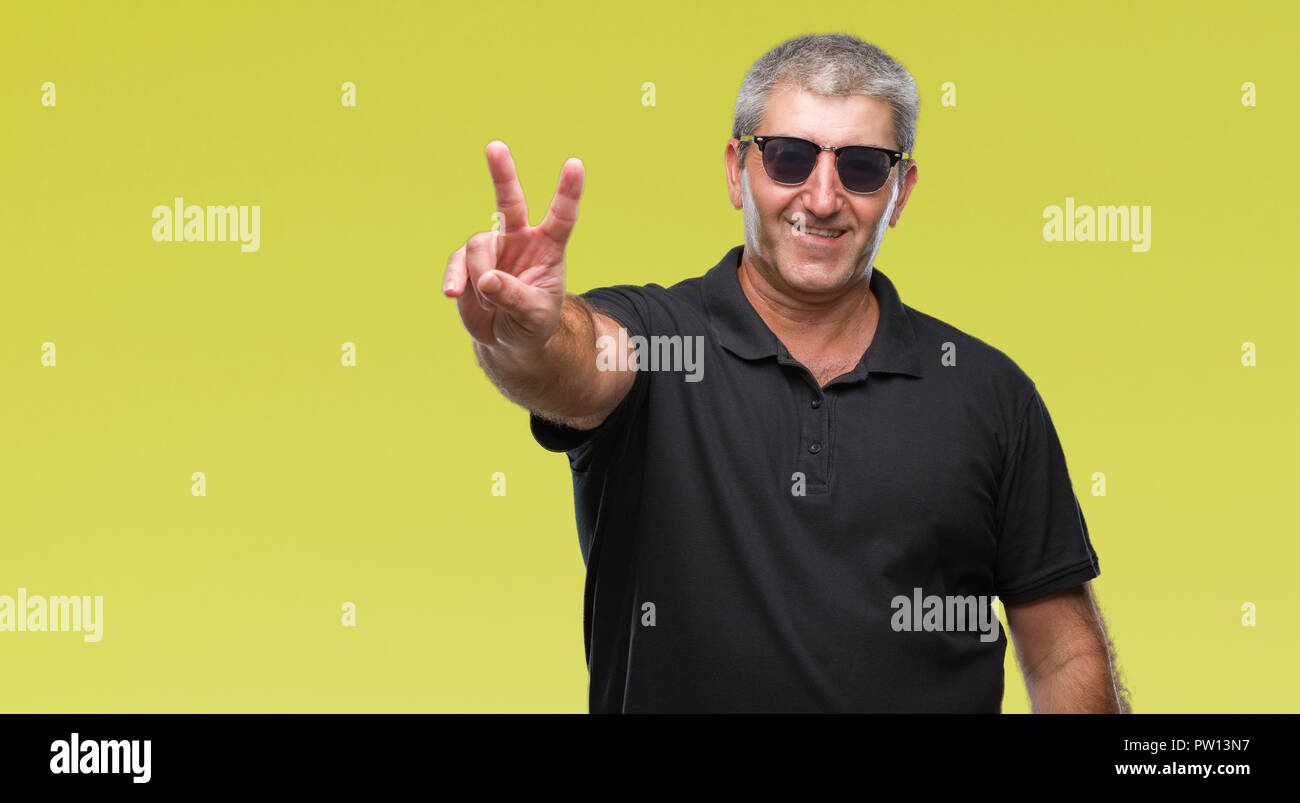 Handsome senior man wearing sunglasses over isolated background smiling ...