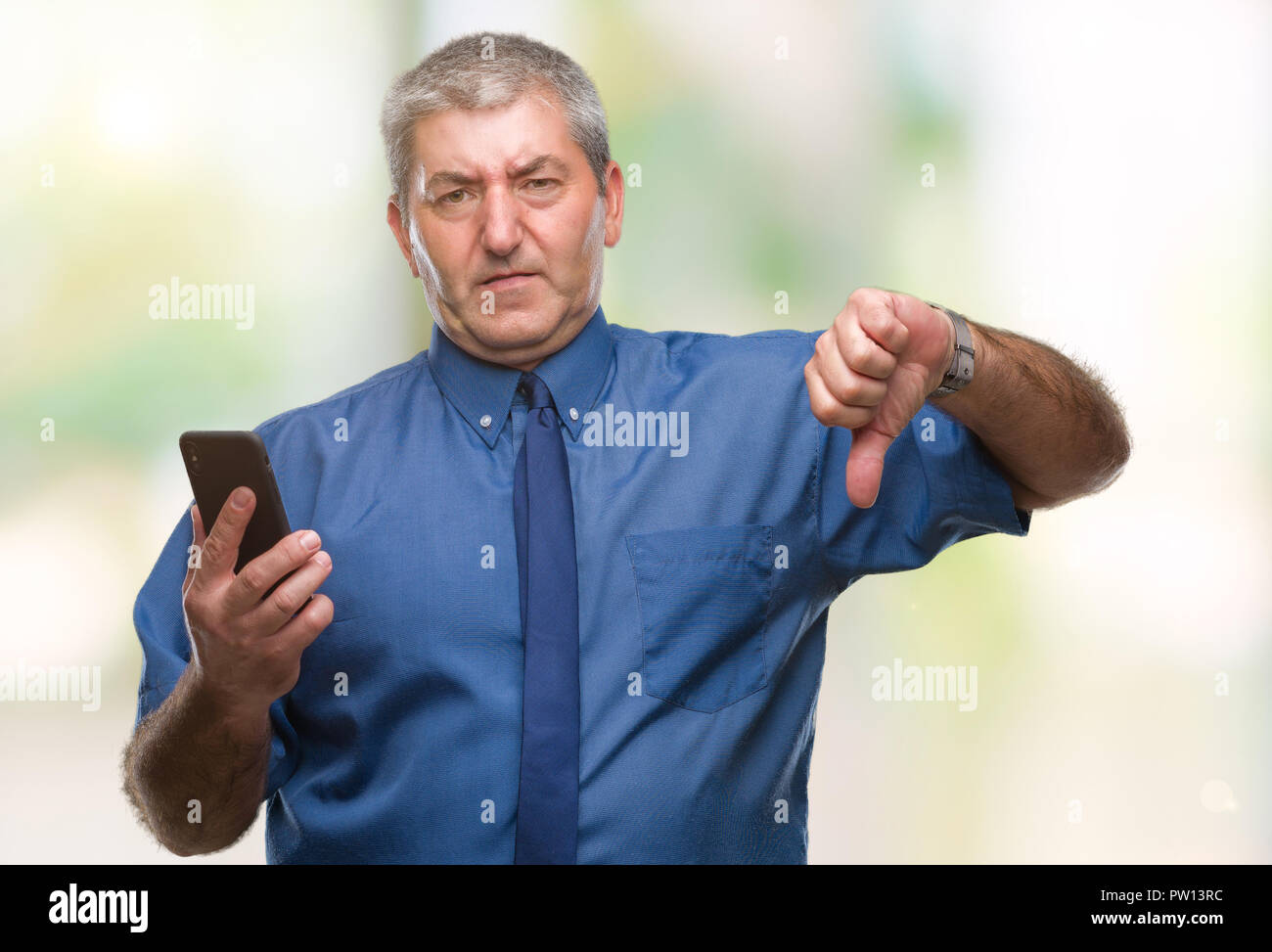 Handsome senior man texting sending message using smartphone over ...