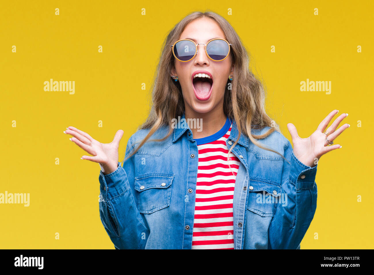 Beautiful young blonde woman wearing sunglasses over isolated ...