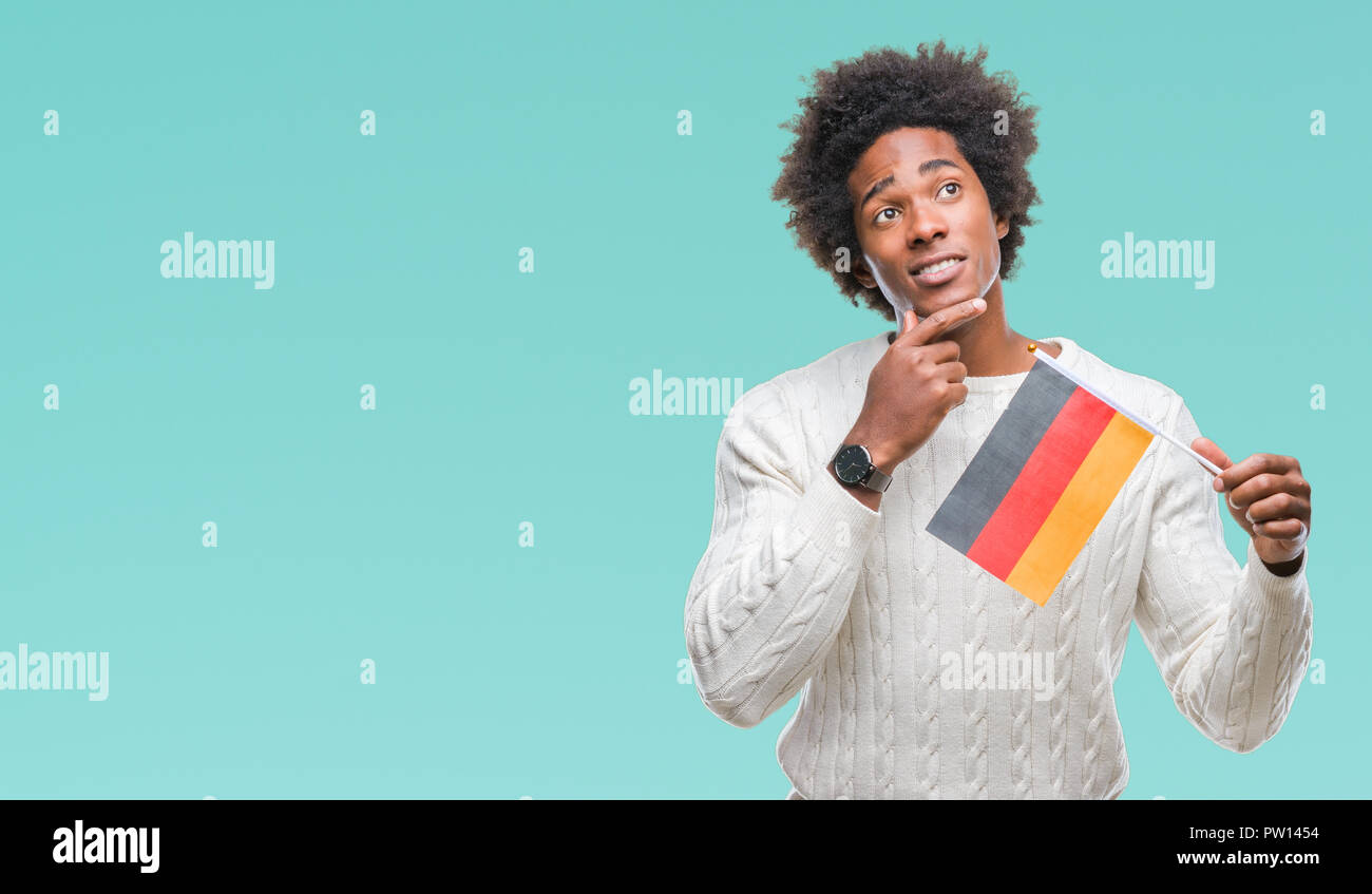 Afro american man flag of Germany over isolated background serious face ...
