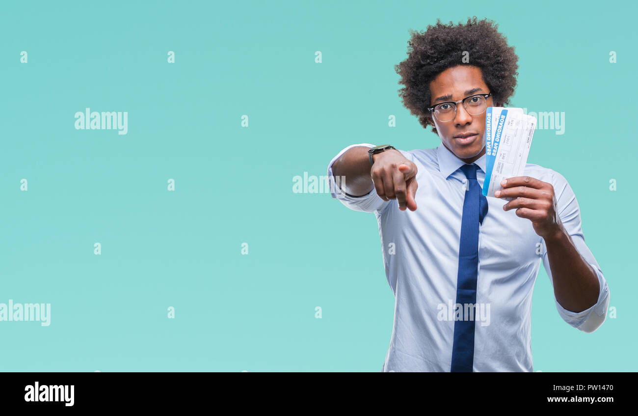 Afro american man holding boarding pass over isolated background ...