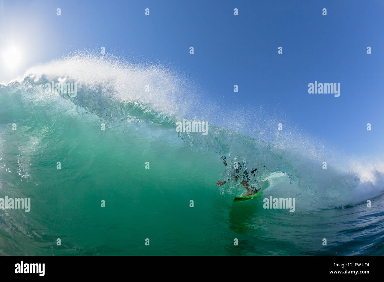 Surfer surfing inside hollow ocean wave close-up water action photo of ...