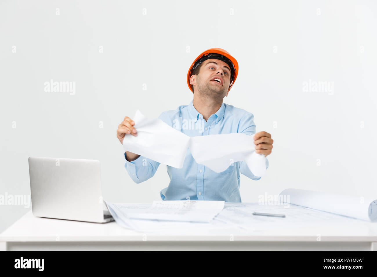 Crazy engineer or architect man with his project in his office. Angry ...