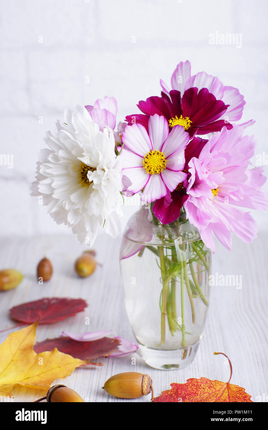 Beautiful and delicate flowers in a glass transparent vase next to ...