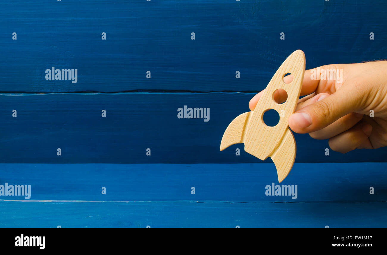 The development of outer space. The hand holds a wooden rocket. The ...