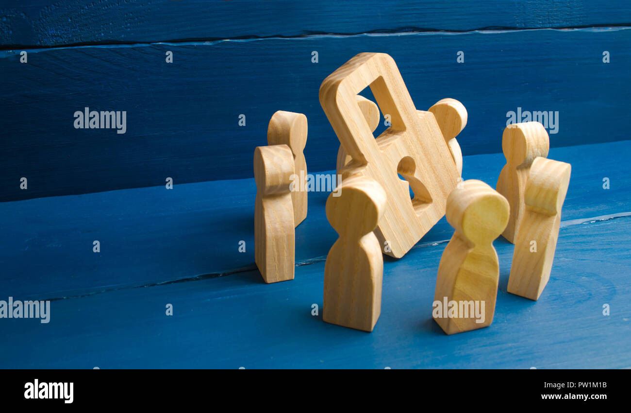 Bank secrecy, medical secret. Wooden figures of people stand around a ...