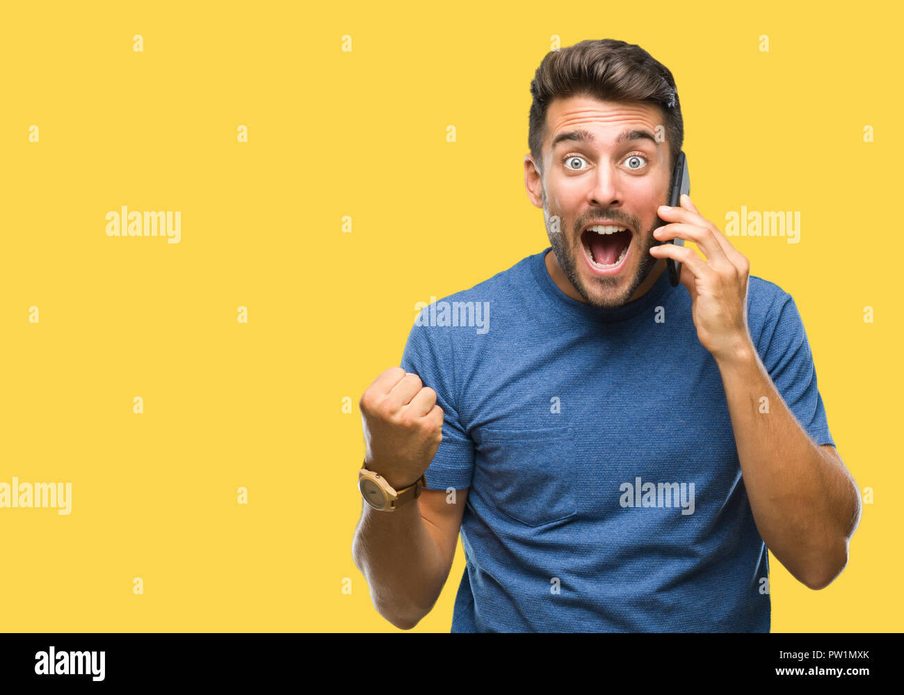 Young handsome man talking on smartphone over isolated background ...