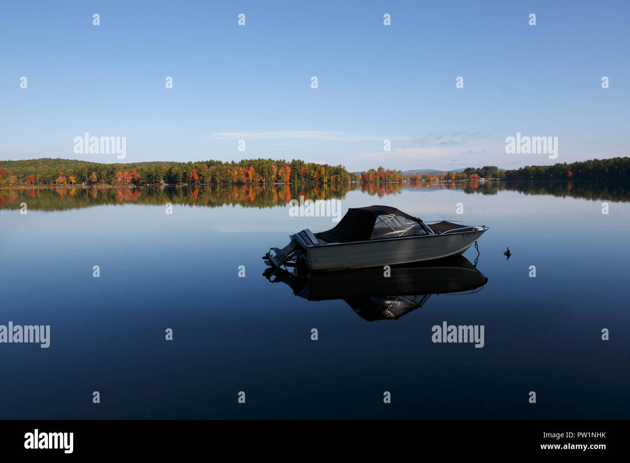 Small boat on Thompson Lake, Oxford, Maine, USA Stock Photo - Alamy