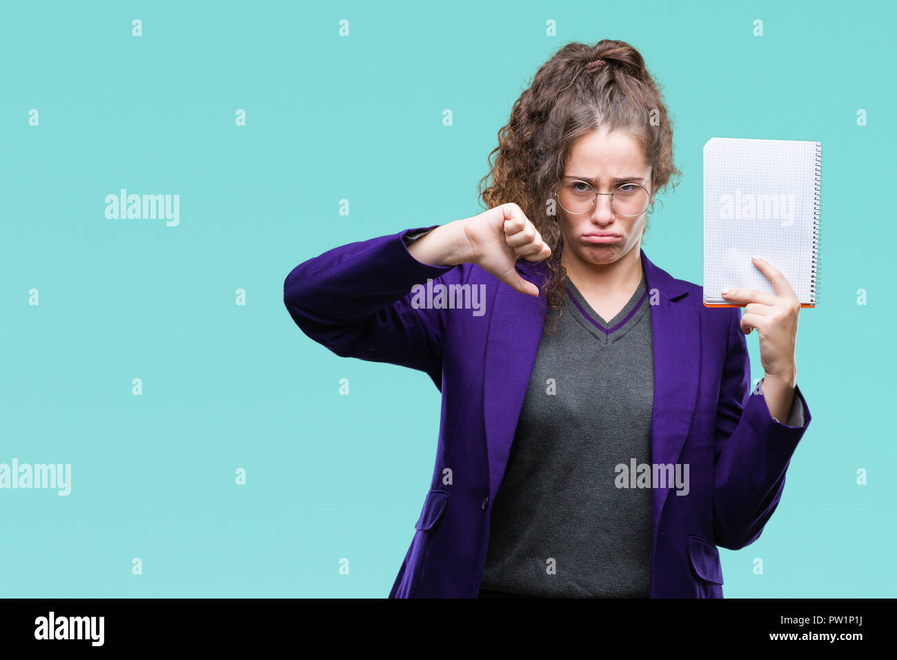 Young brunette student girl wearing school uniform holding a notebook ...