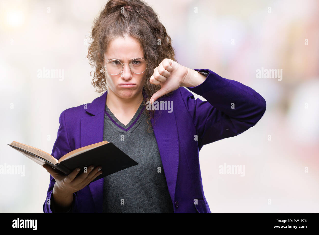 Young brunette student girl wearing school uniform reading a book over ...