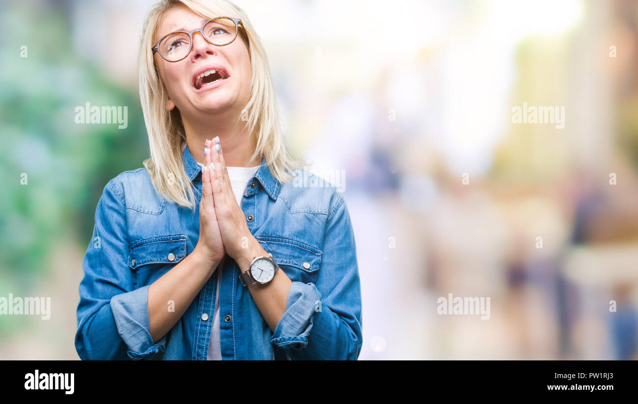 Young beautiful blonde woman wearing glasses over isolated background ...