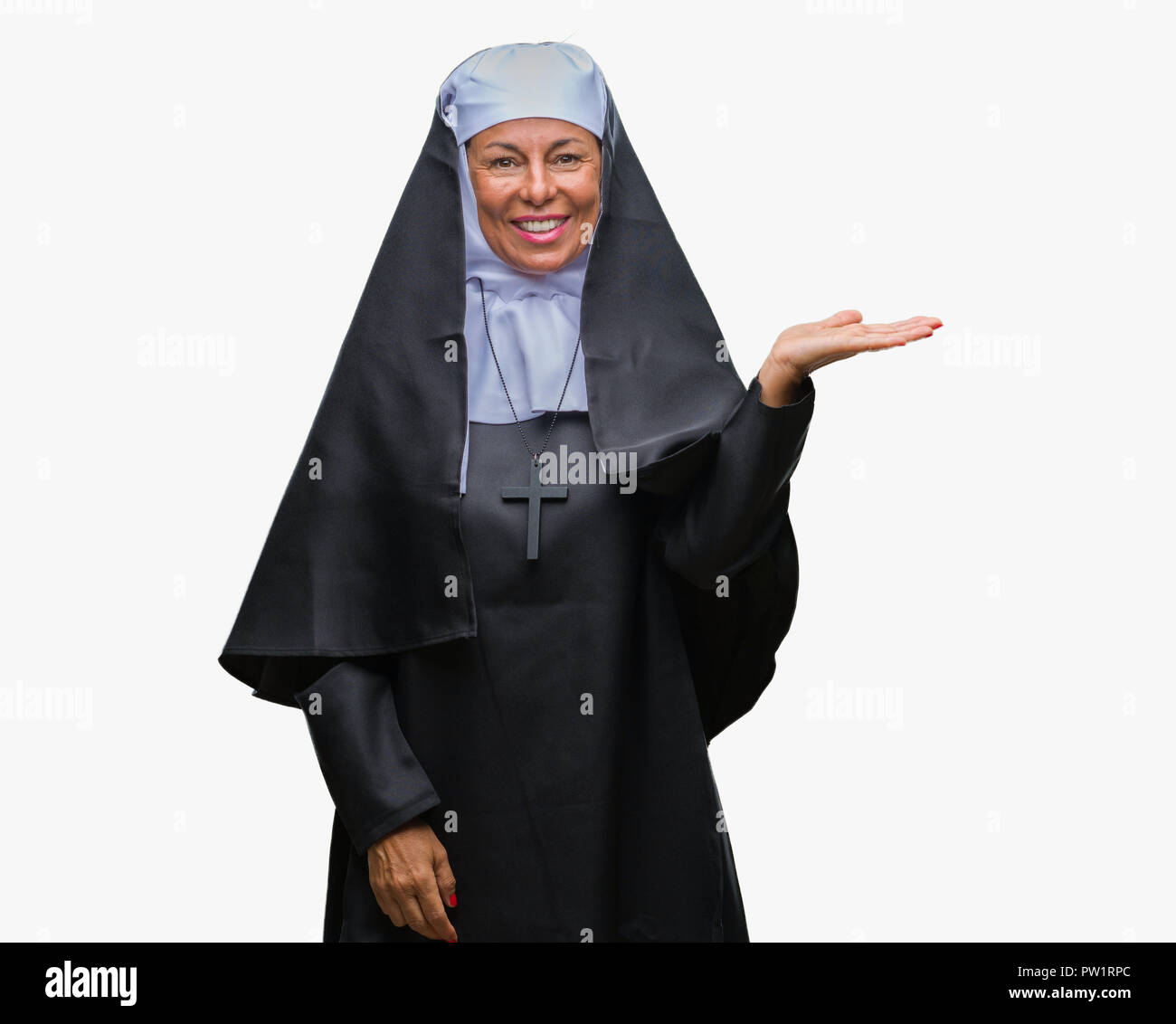 Middle age senior christian catholic nun woman over isolated background ...