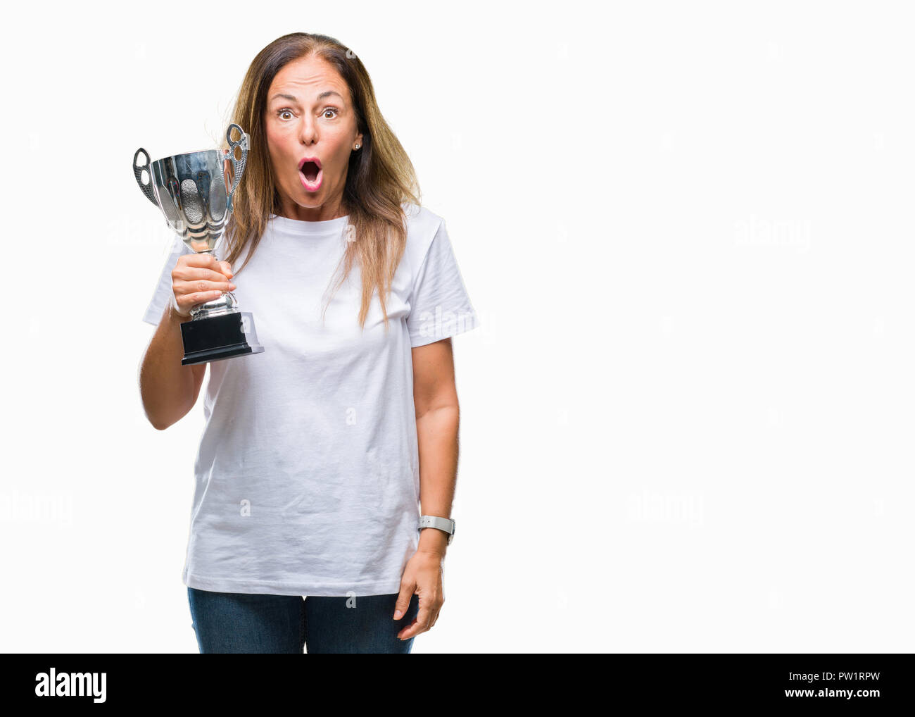Middle age hispanic winner woman celebrating award holding trophy over ...