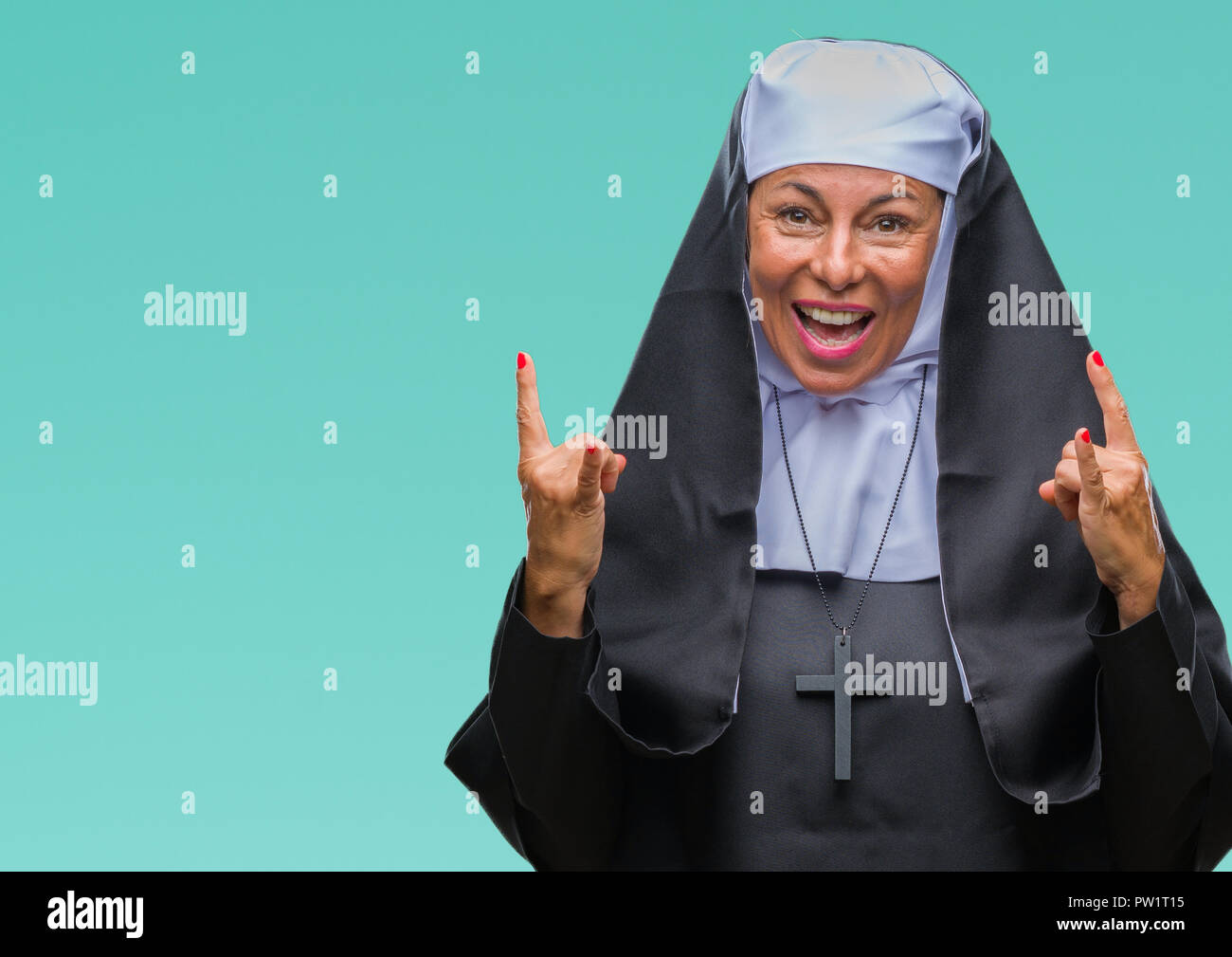 Middle age senior christian catholic nun woman over isolated background ...
