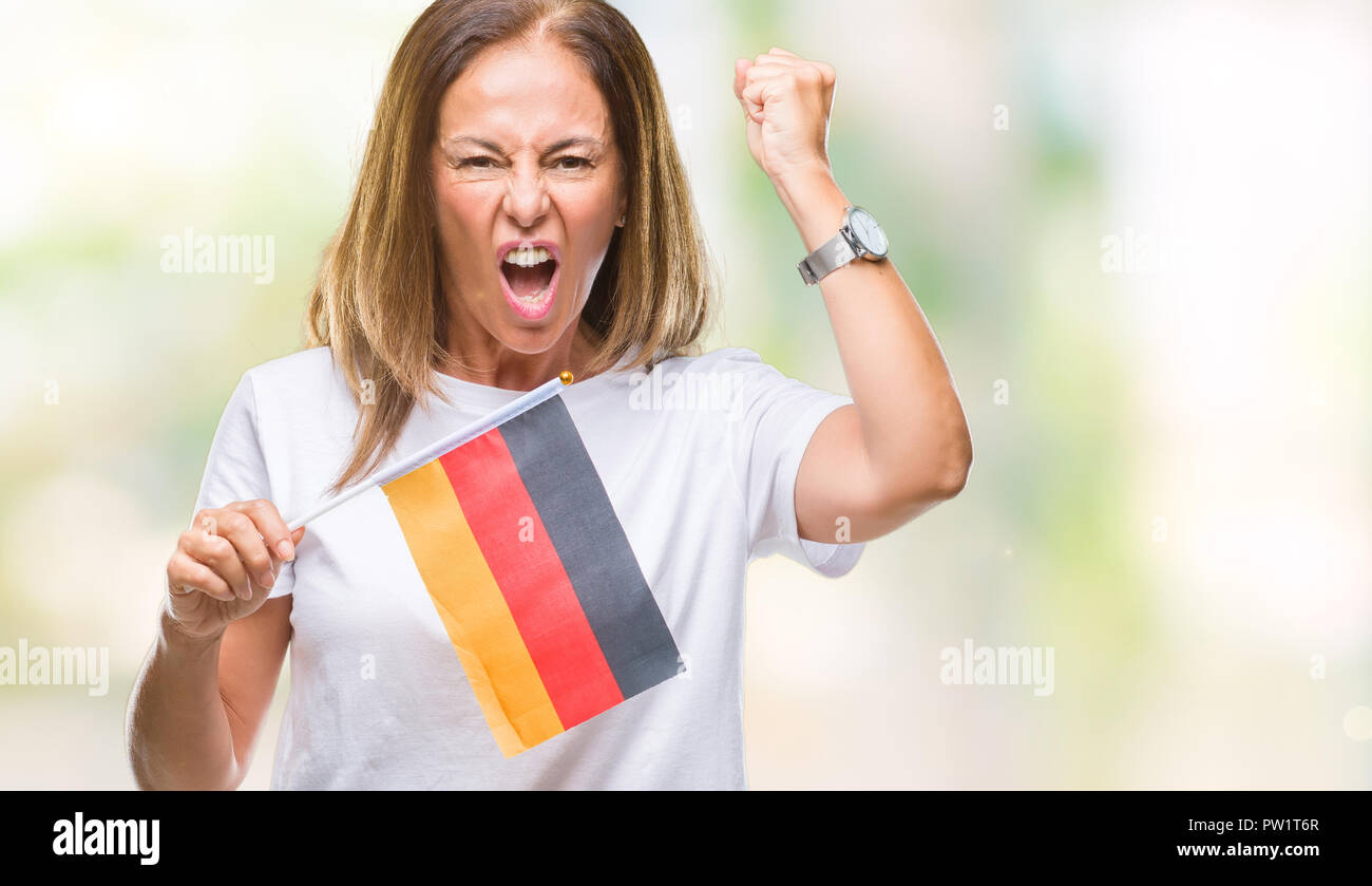 Middle age hispanic woman holding flag of Germany over isolated ...