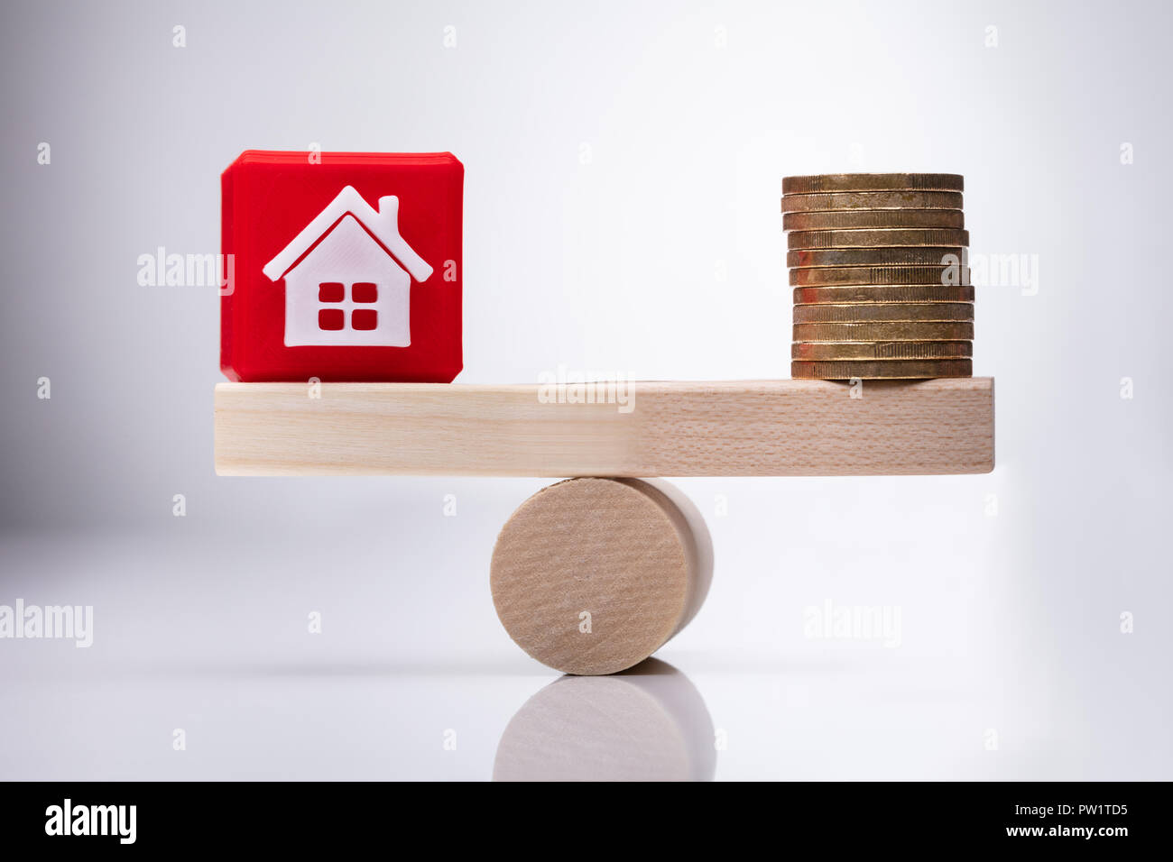 Red House Model Cubic Block And Stacked Golden Coins Balancing On ...