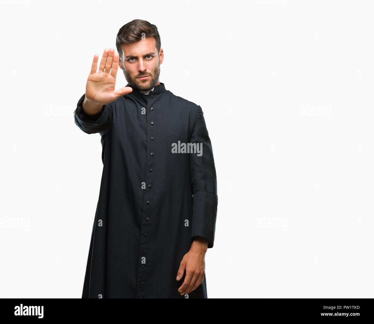 Young catholic christian priest man over isolated background doing stop ...